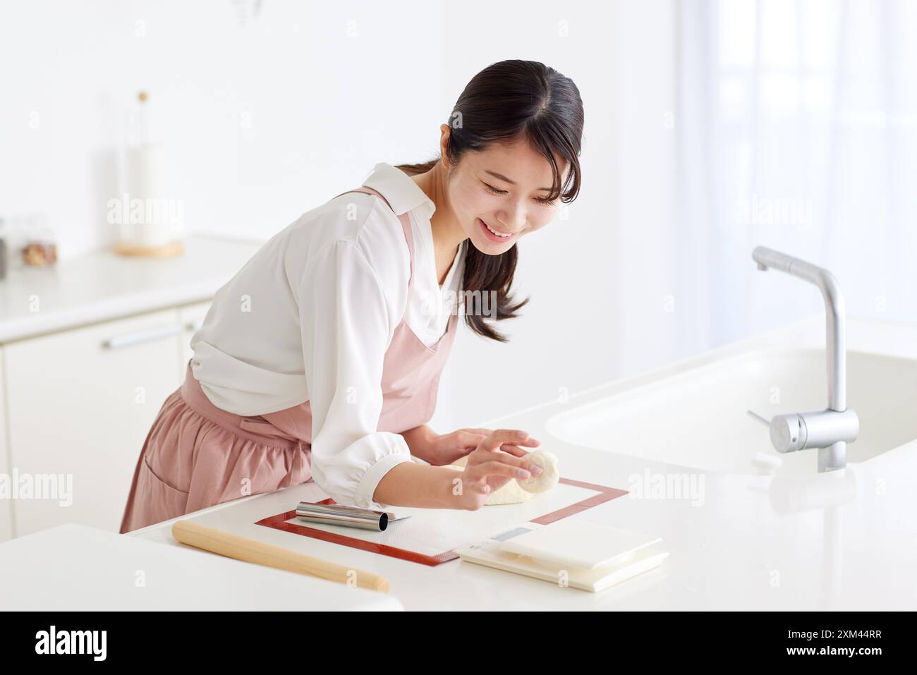 Japanese woman cooking in the kitchen Stock Photo - Alamy