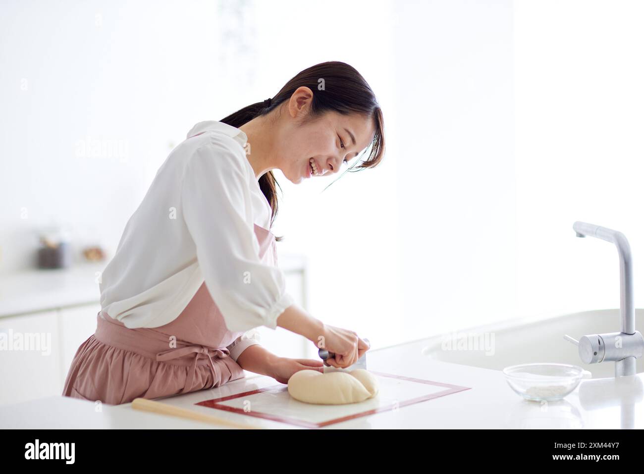 Japanese woman cooking in the kitchen Stock Photo - Alamy