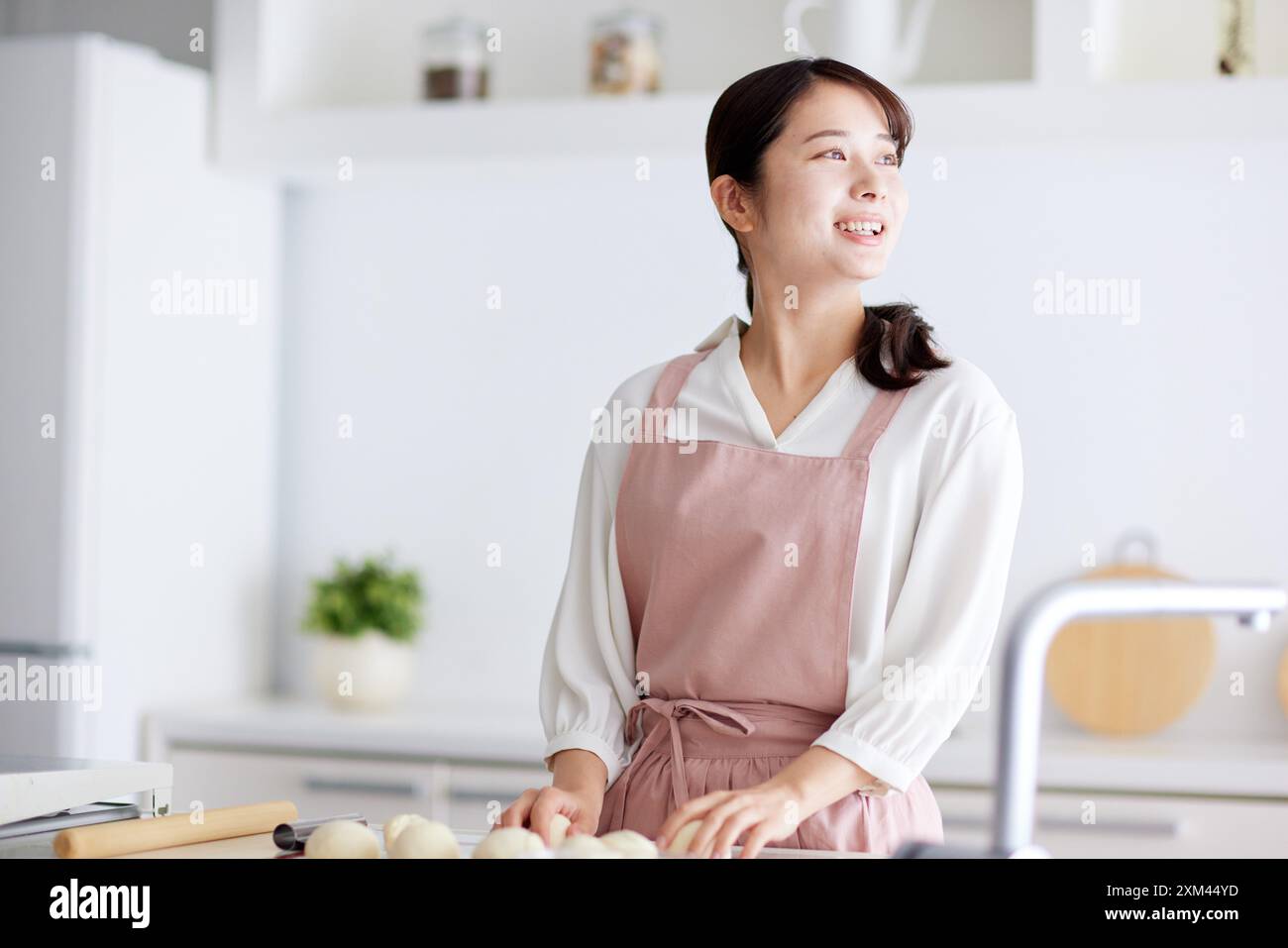 Japanese woman cooking in the kitchen Stock Photo - Alamy