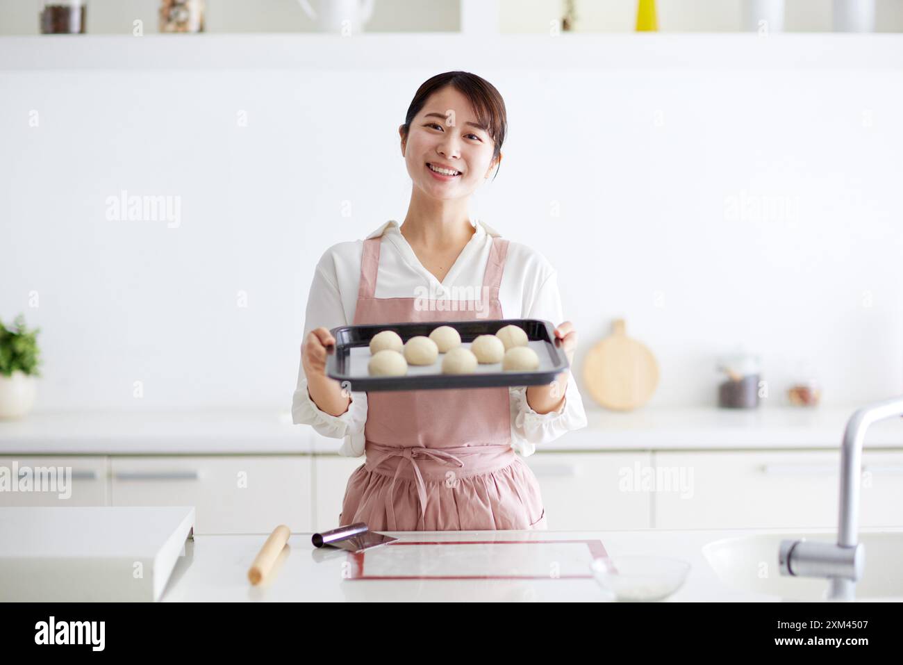 Japanese woman cooking in the kitchen Stock Photo - Alamy