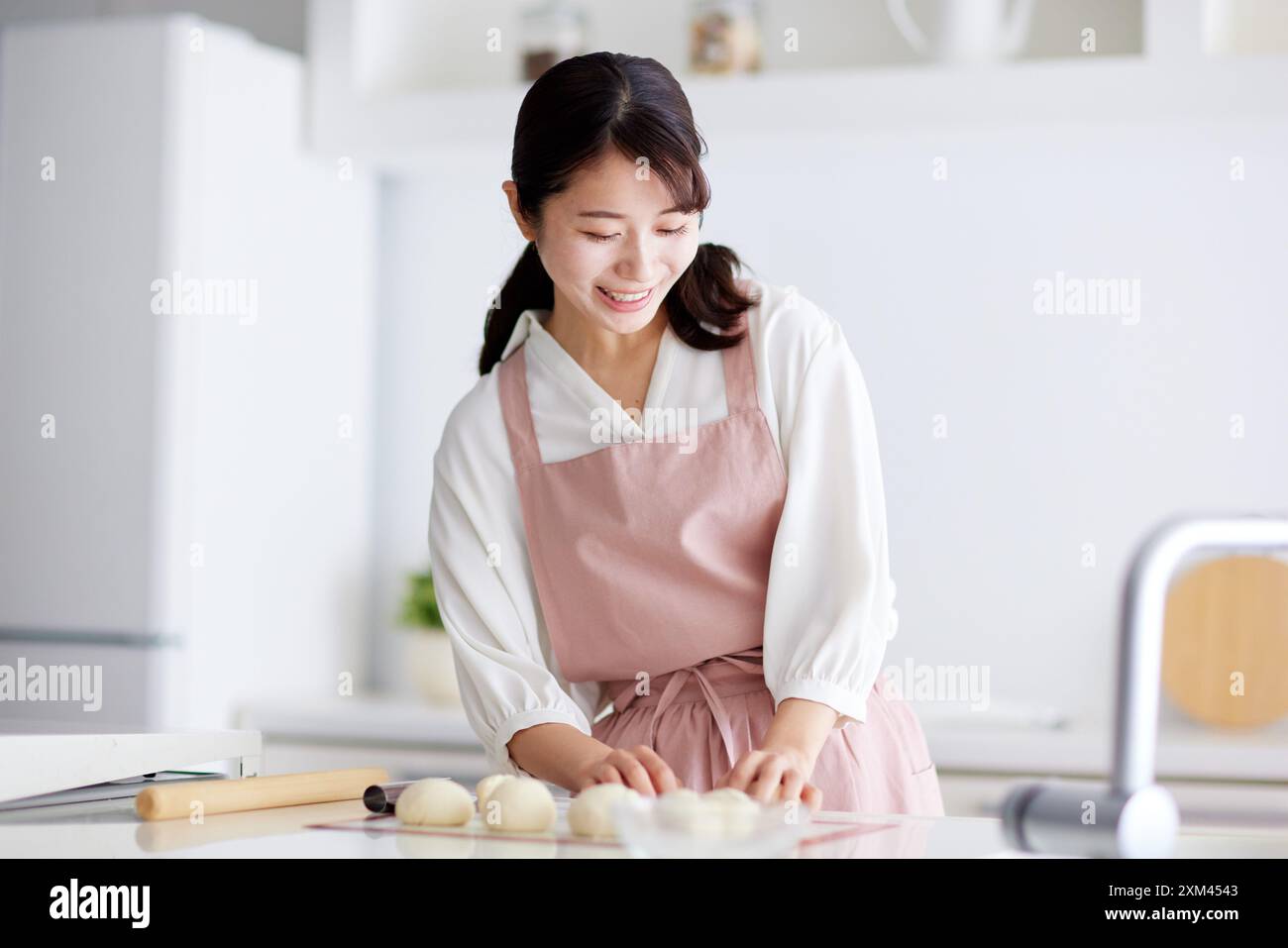 Japanese woman cooking in the kitchen Stock Photo - Alamy