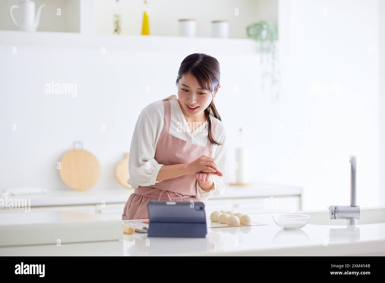 Japanese woman cooking in the kitchen Stock Photo - Alamy