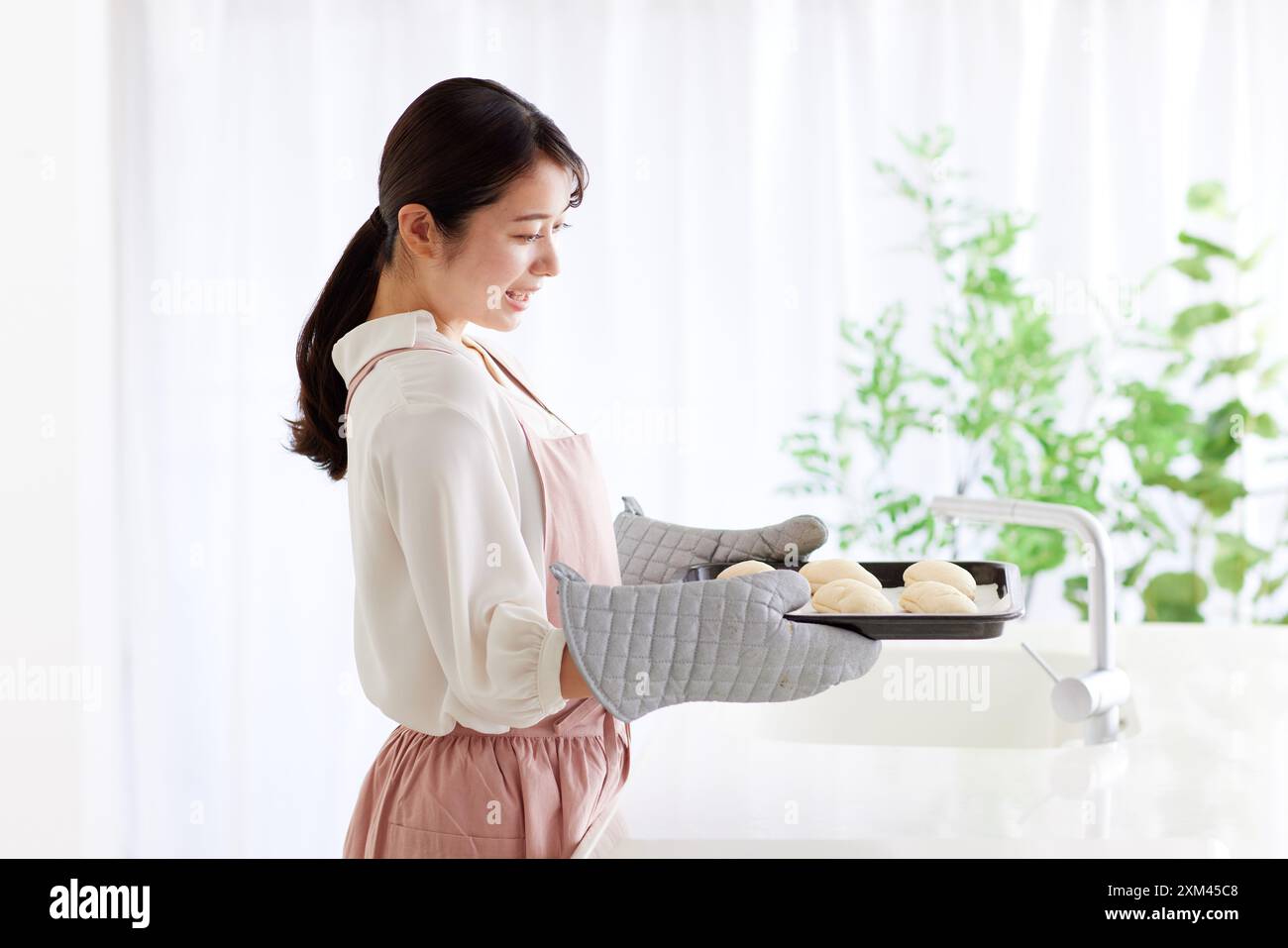 Japanese woman cooking in the kitchen Stock Photo - Alamy