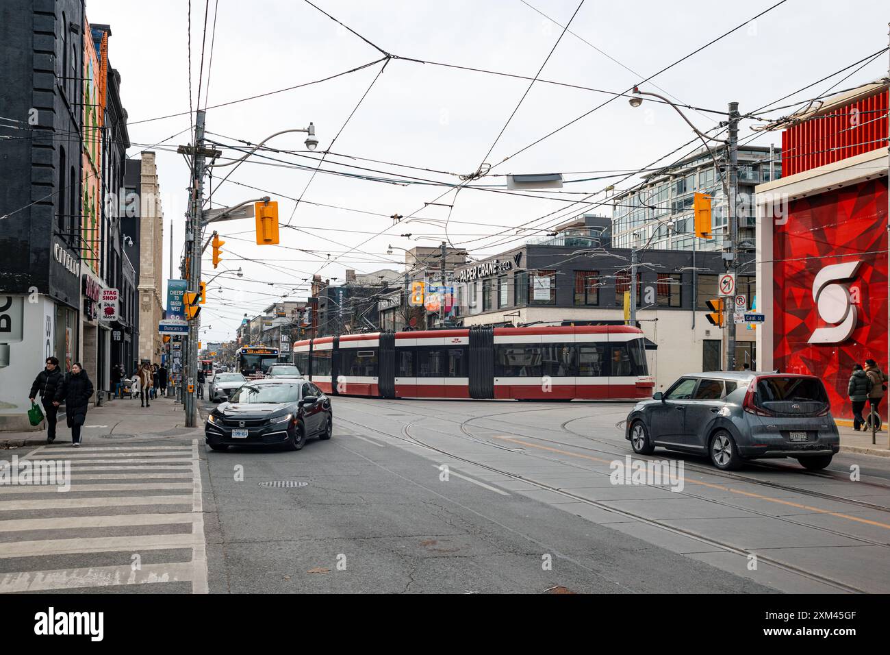 Intersection on Queen Street, Toronto with cars and TTC streetcar ...