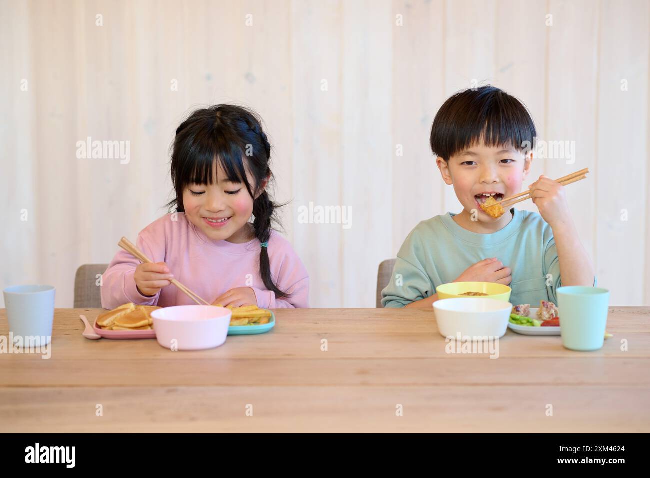 Girl child eating with chopsticks hi-res stock photography and images ...