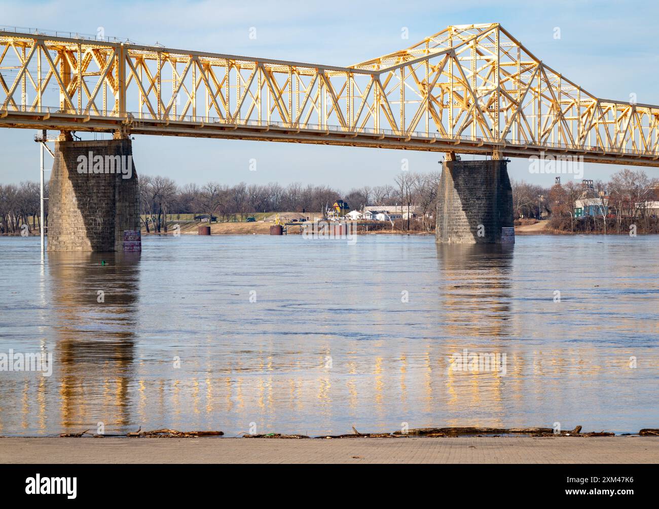 Four-lane cantilevered steel truss bridge painted yellow spanning large ...