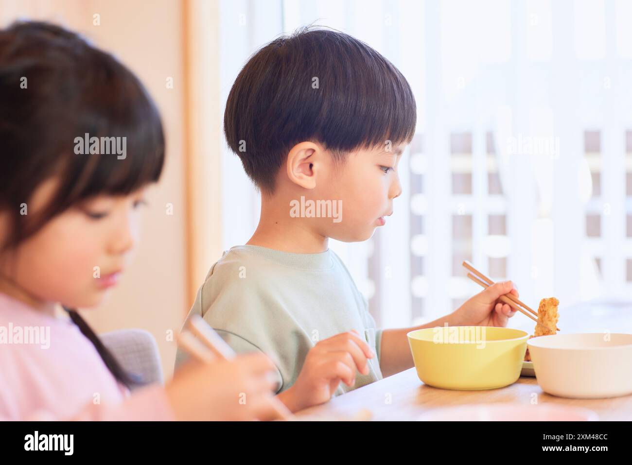 Happy Japanese kids eating in the dining room Stock Photo - Alamy