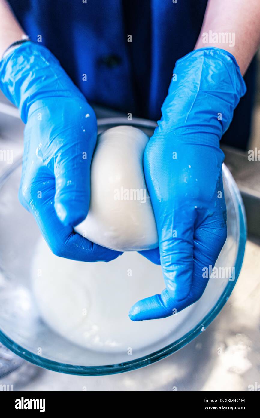 A woman working in a small family butter mill completes the final ...