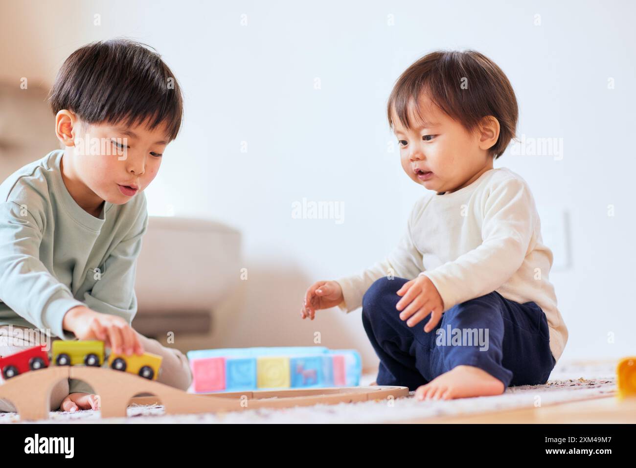 Happy Japanese kids playing on the floor Stock Photo - Alamy