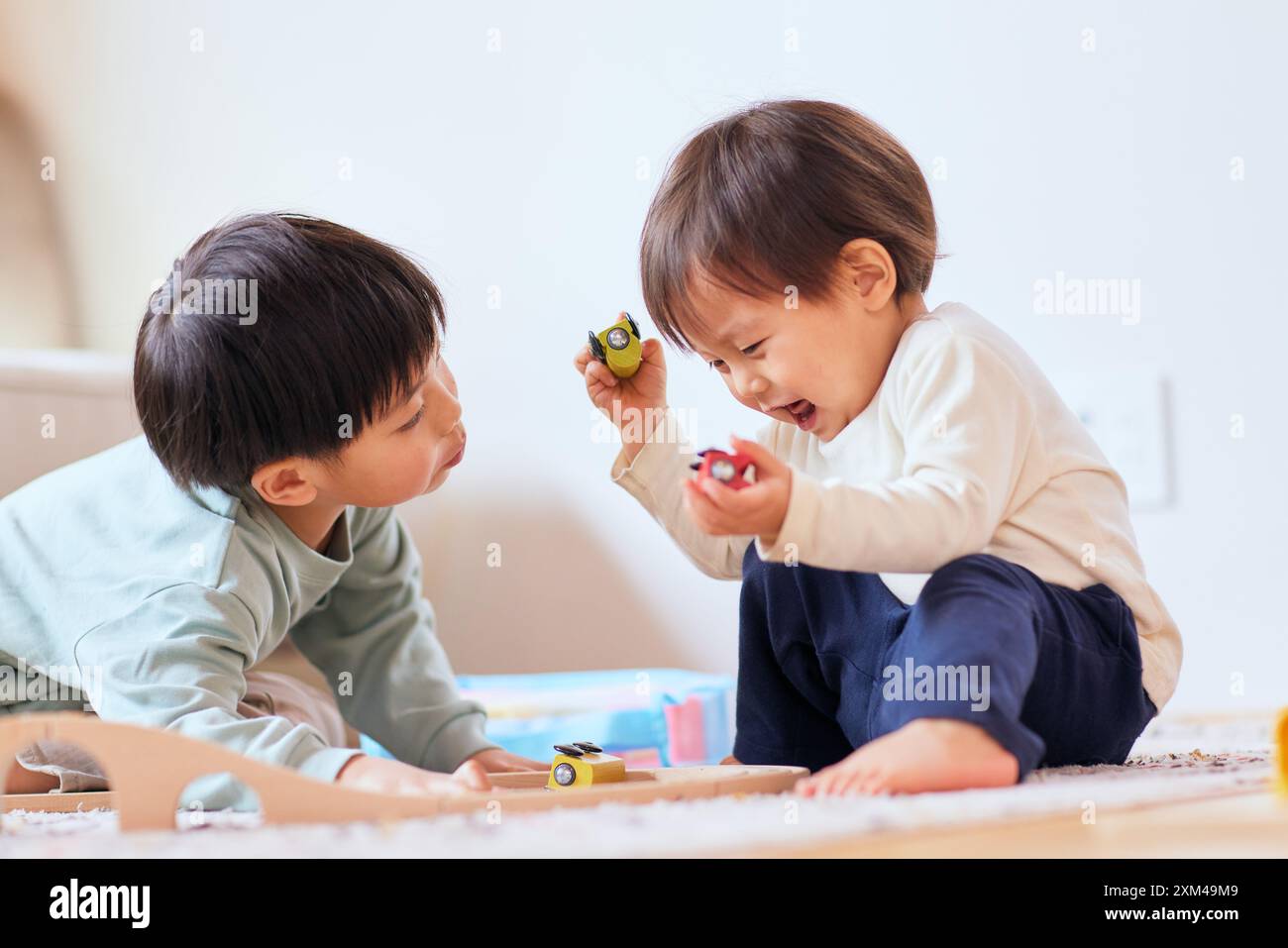 Happy Japanese kids playing on the floor Stock Photo - Alamy