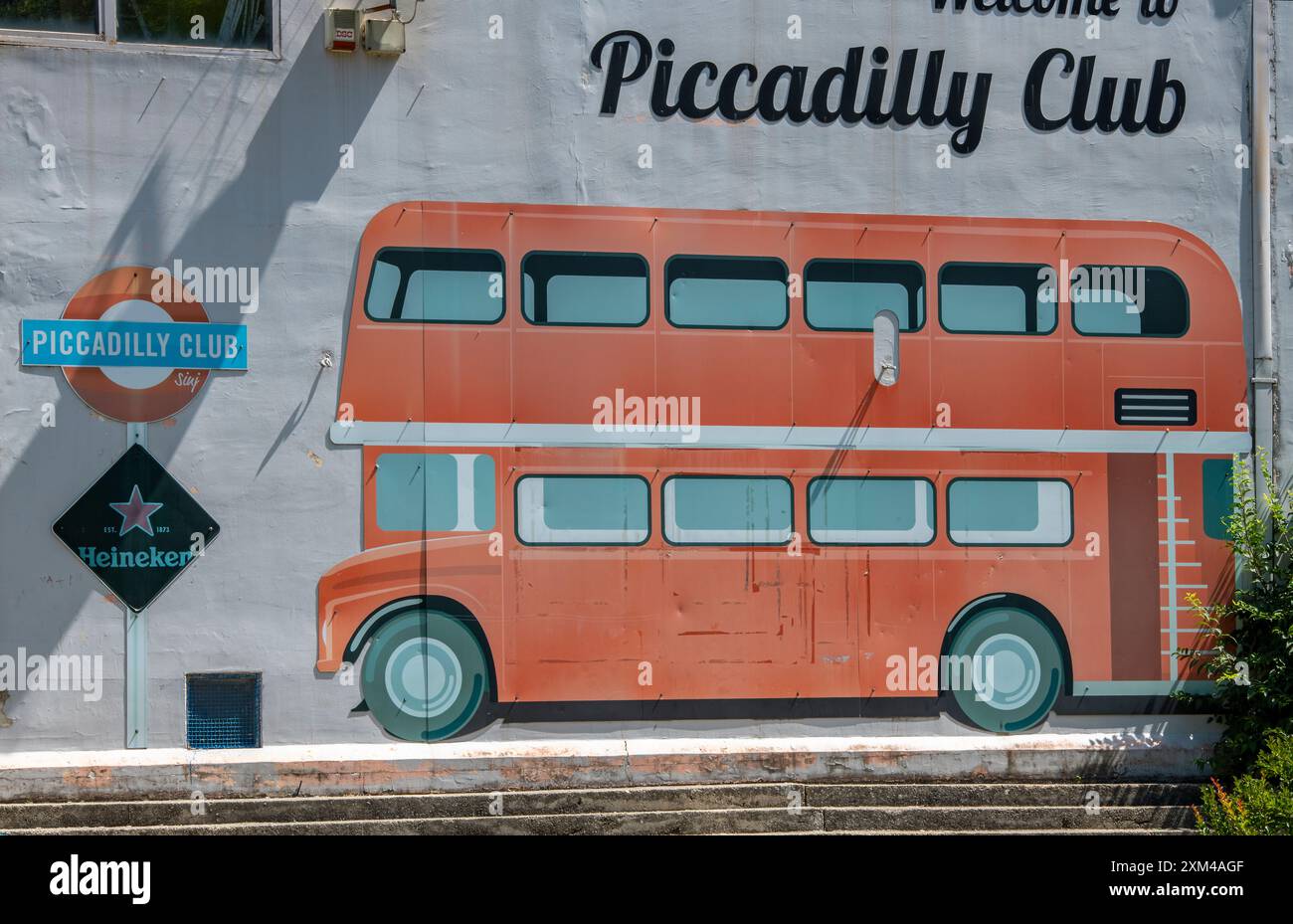 sign advertising the piccadilly club with a london routemaster red bus ...