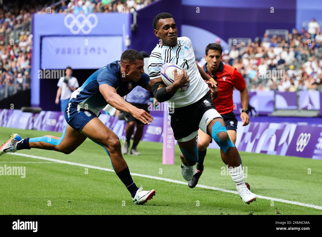 Paris, France, 25 July, 2024. Joji Nasova (1) of Team Fiji scores a try ...