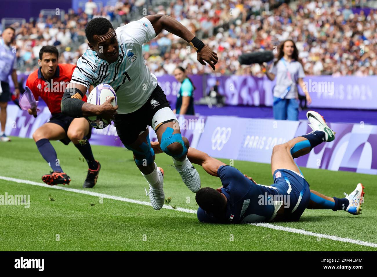 Paris, France, 25 July, 2024. Joji Nasova (1) of Team Fiji scores a try ...