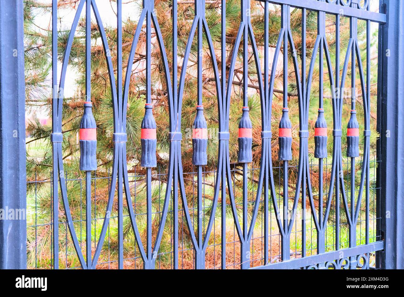 Detail of black, wrought iron steel fence coke bottle artwork design ...