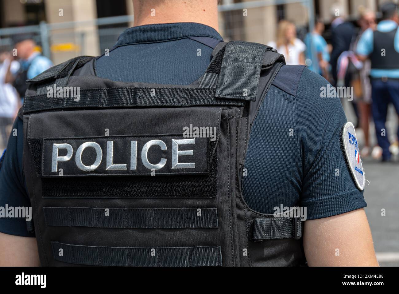 "POLICE" marking written on the back of a bulletproof vest worn by a ...