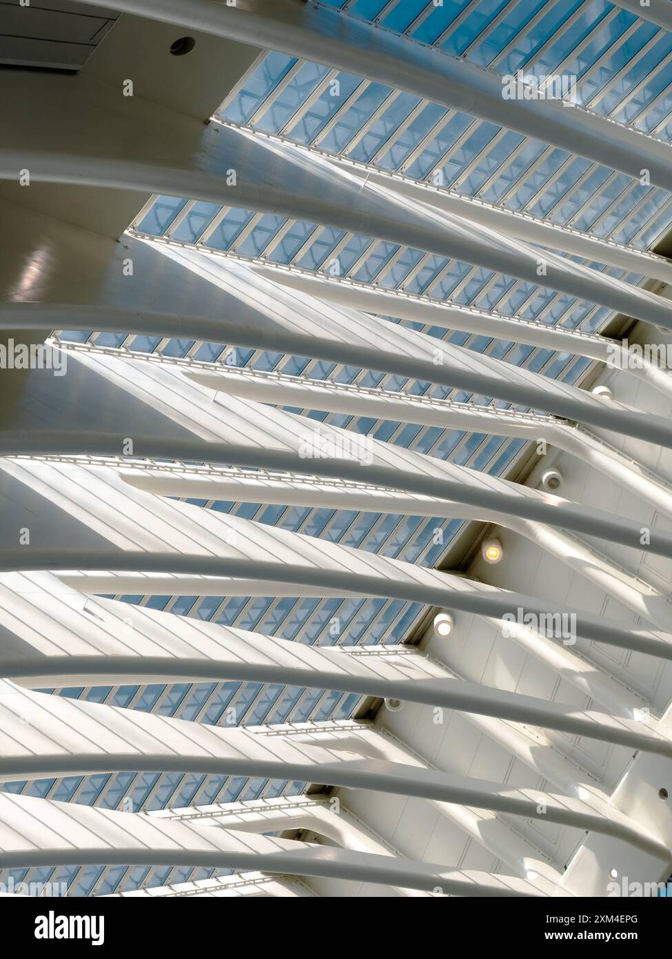Interior view of a modern building featuring sunlit structural beams ...