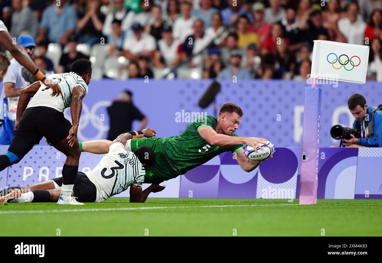 Ireland's Zac Ward scores a try during the rugby sevens match against ...