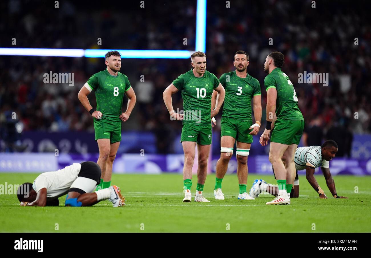 Ireland players appear dejected following the rugby sevens match match ...