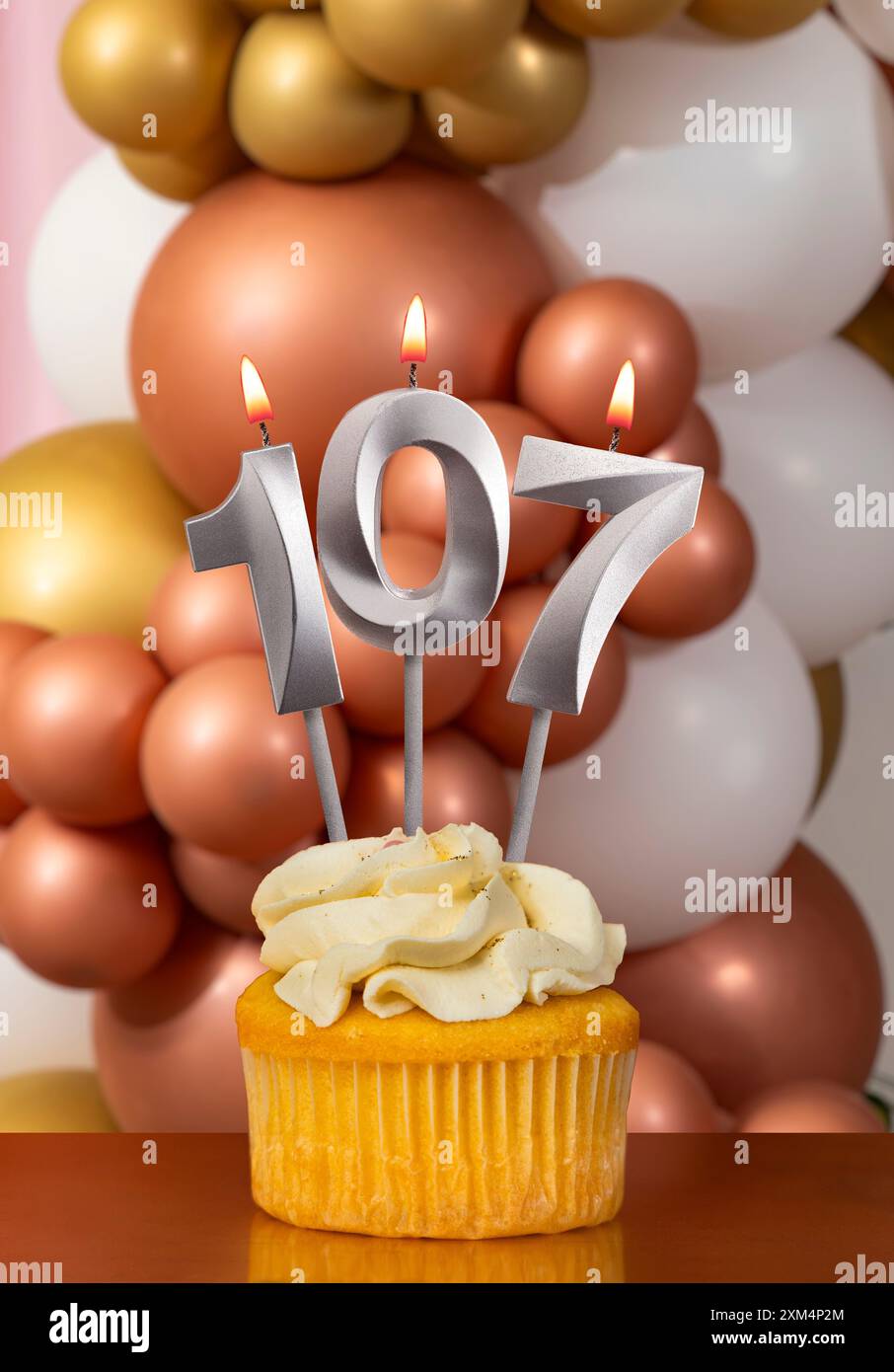 Cupcake with birthday candle on balloons background - Number 107 Stock ...