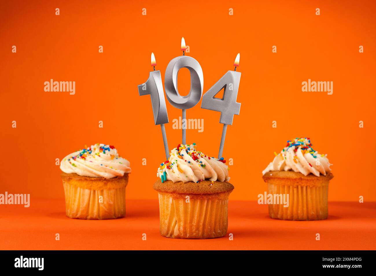 Birthday celebration in orange color - Candle number 104 Stock Photo ...