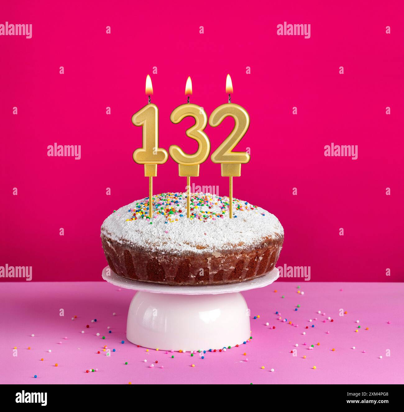 Lighted birthday candle number 132 - Birthday card on pink background ...