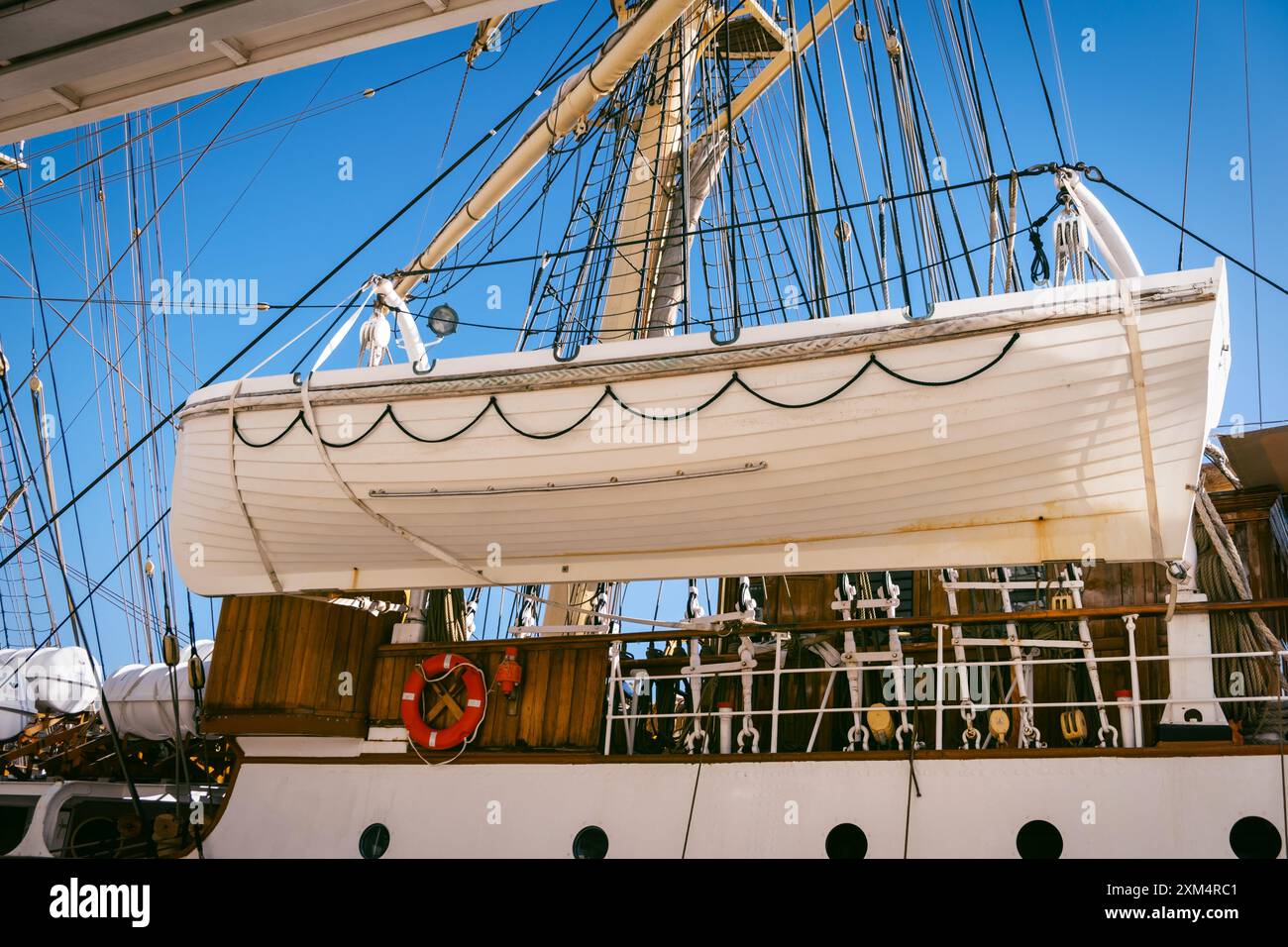 Lifeboat on sailing ship deck, clear blue sky background. Features ...