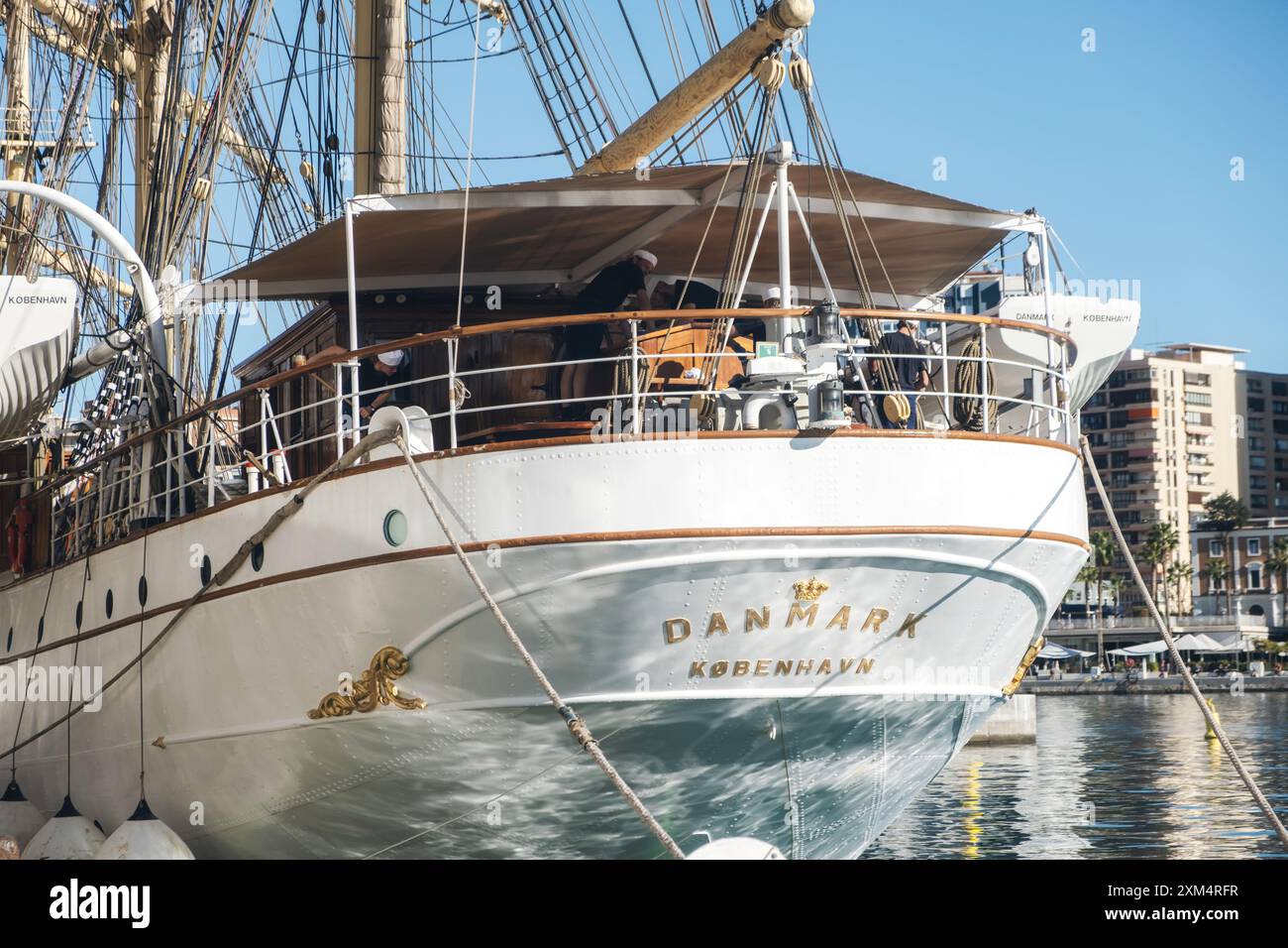 Danish traditional tall ship 'Danmark' docked at urban harbor. Features ...