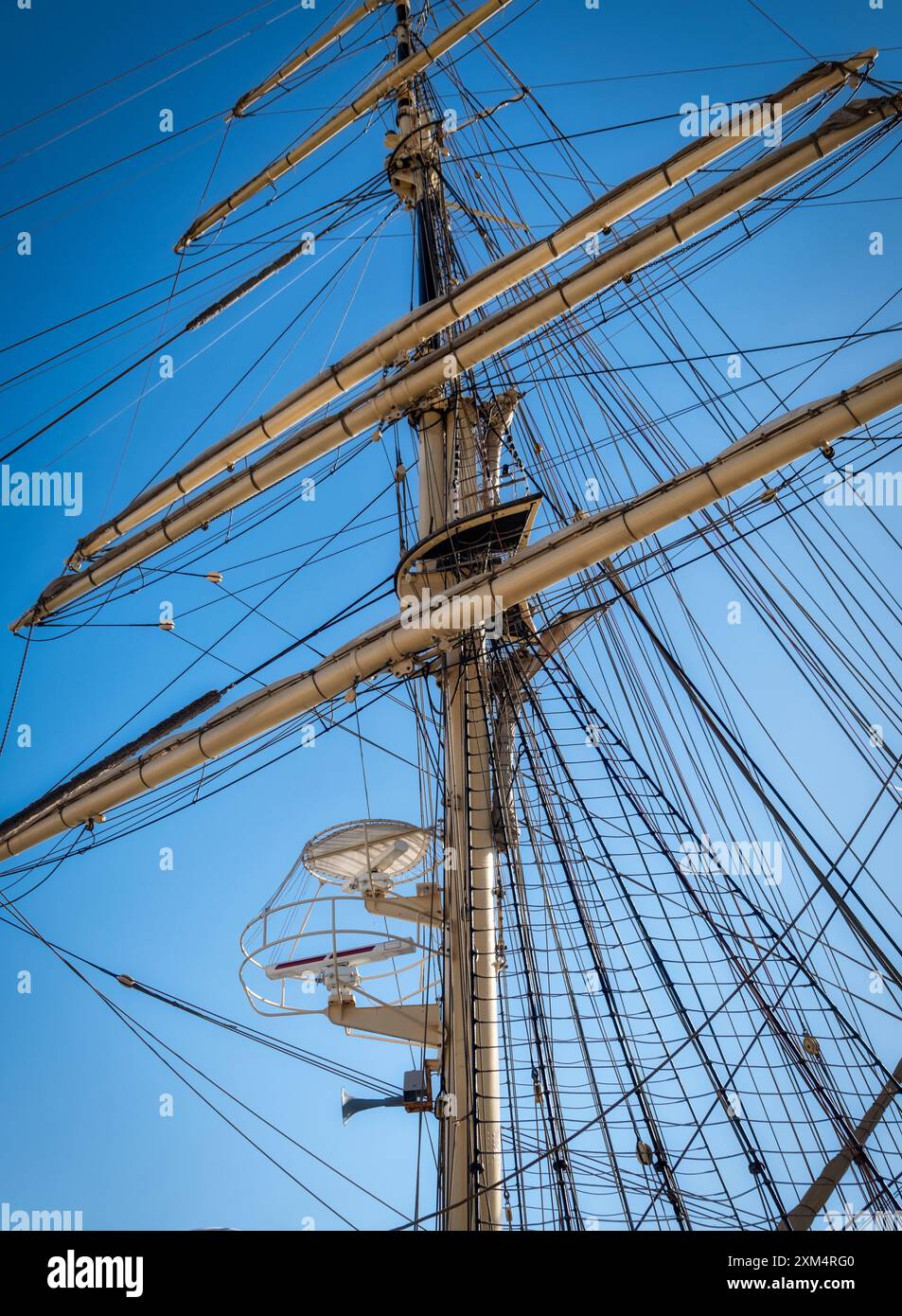 Tall ship mast, rigging, yards against clear sky. Classic sailing ...
