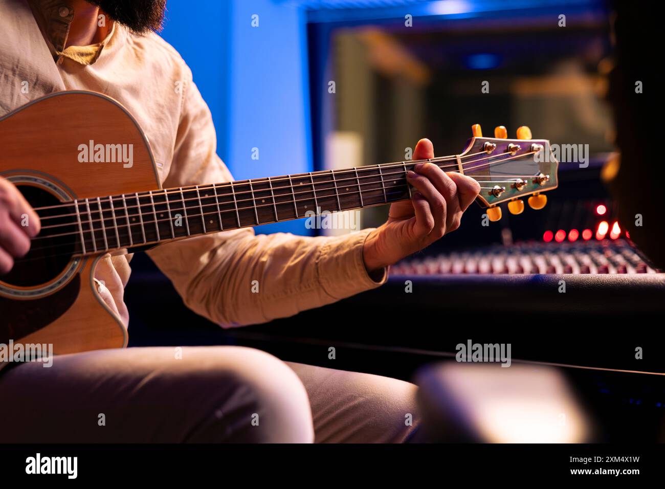 Talented singer playing electro acoustic guitar in music recording ...