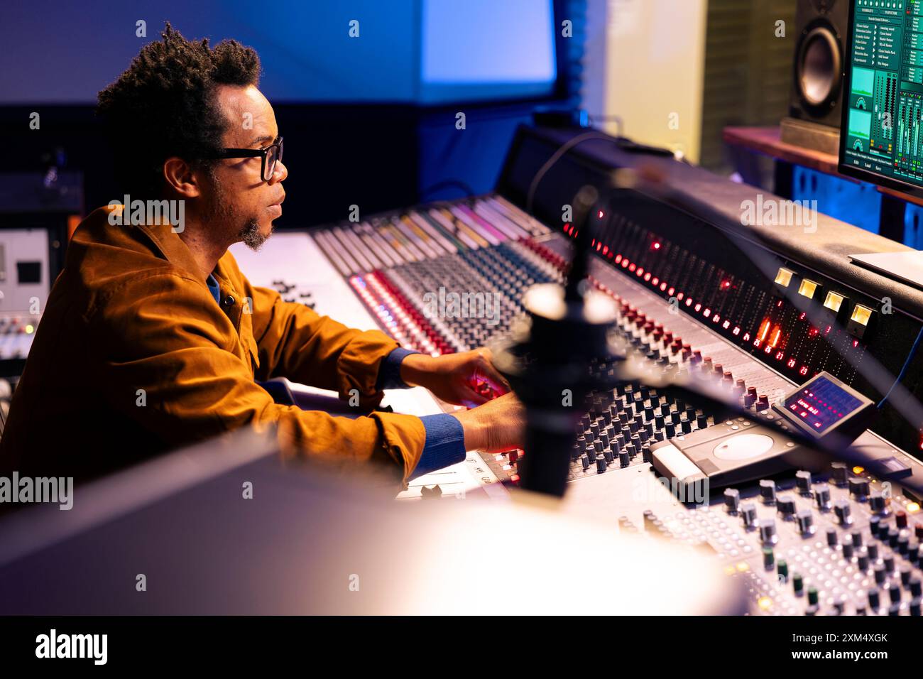 African american audio engineer mixing and mastering music with ...