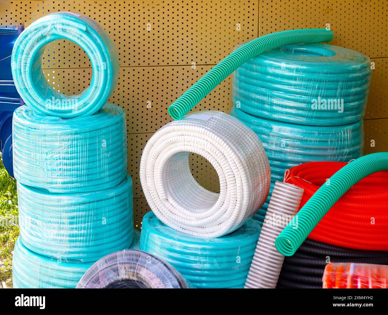 Plastic water pipes hoses rolled in circles sold outside on market ...