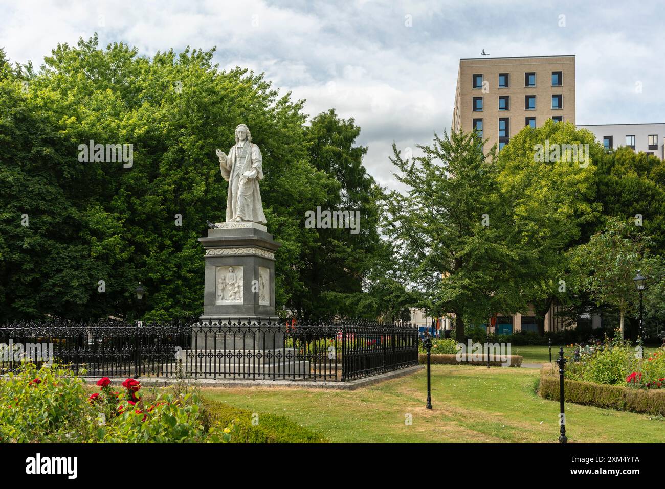 Isaac Watts monument memorial statue against a backdrop of trees and buildings in Watts Park ...