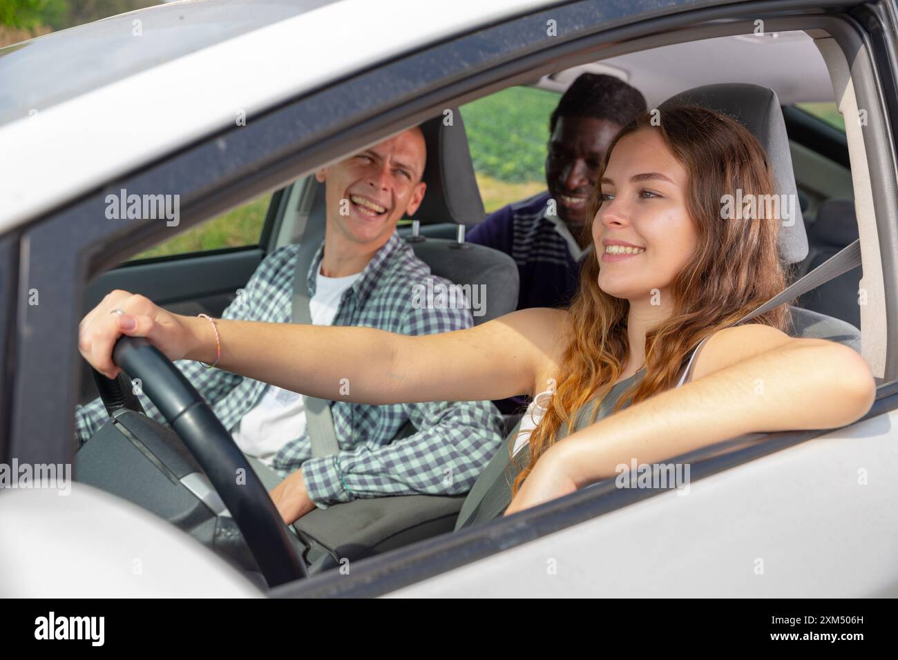 Happy friends driving in the car with open windows Stock Photo - Alamy