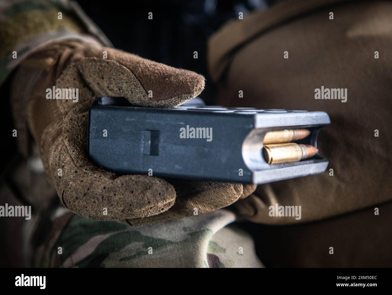 A U.S. Army Soldier checks his magazine on a UH-60 Black Hawk during ...