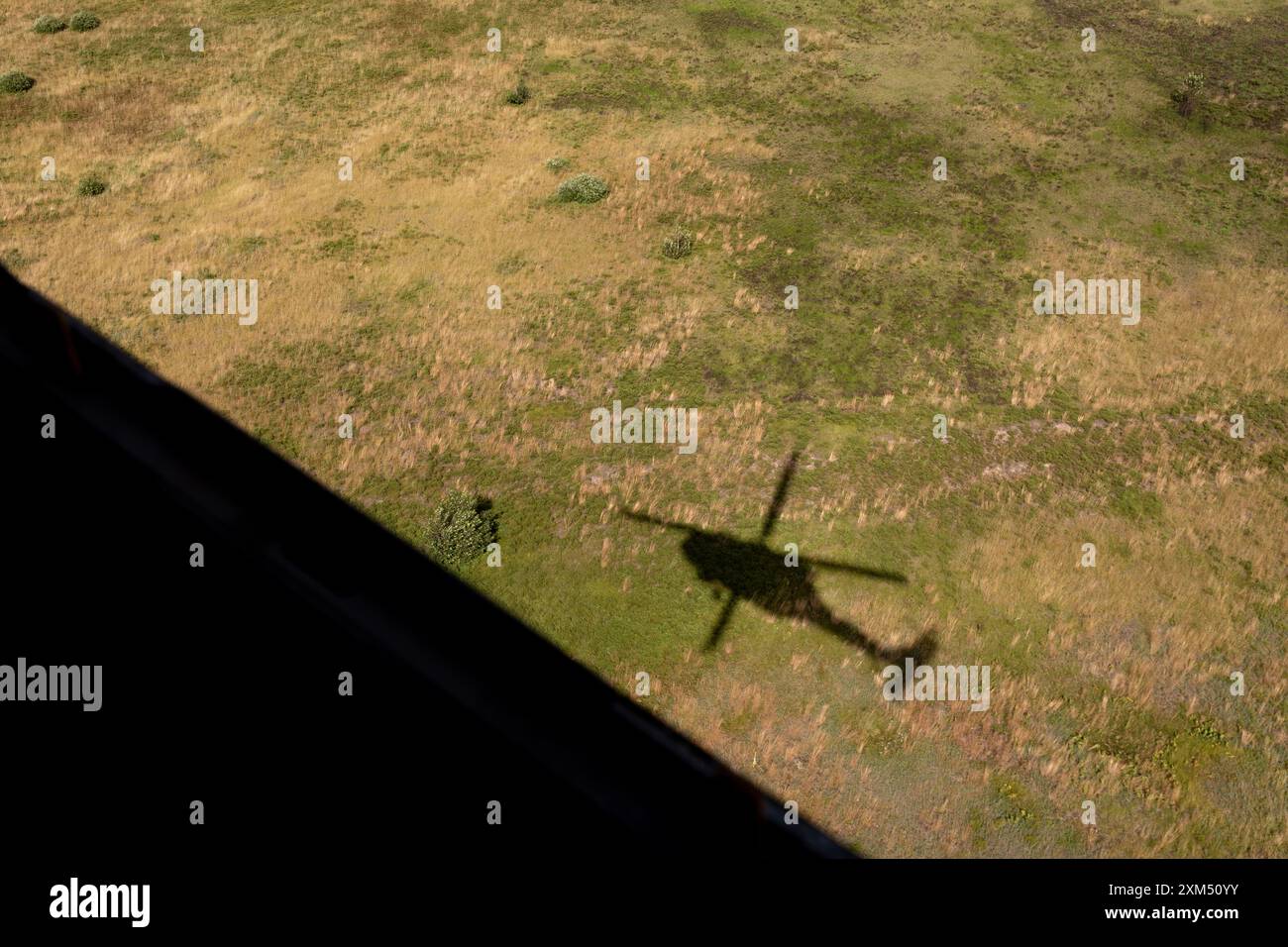 The shadow of a UH-60 Blackhawk helicopter over Camp Grayling Army ...