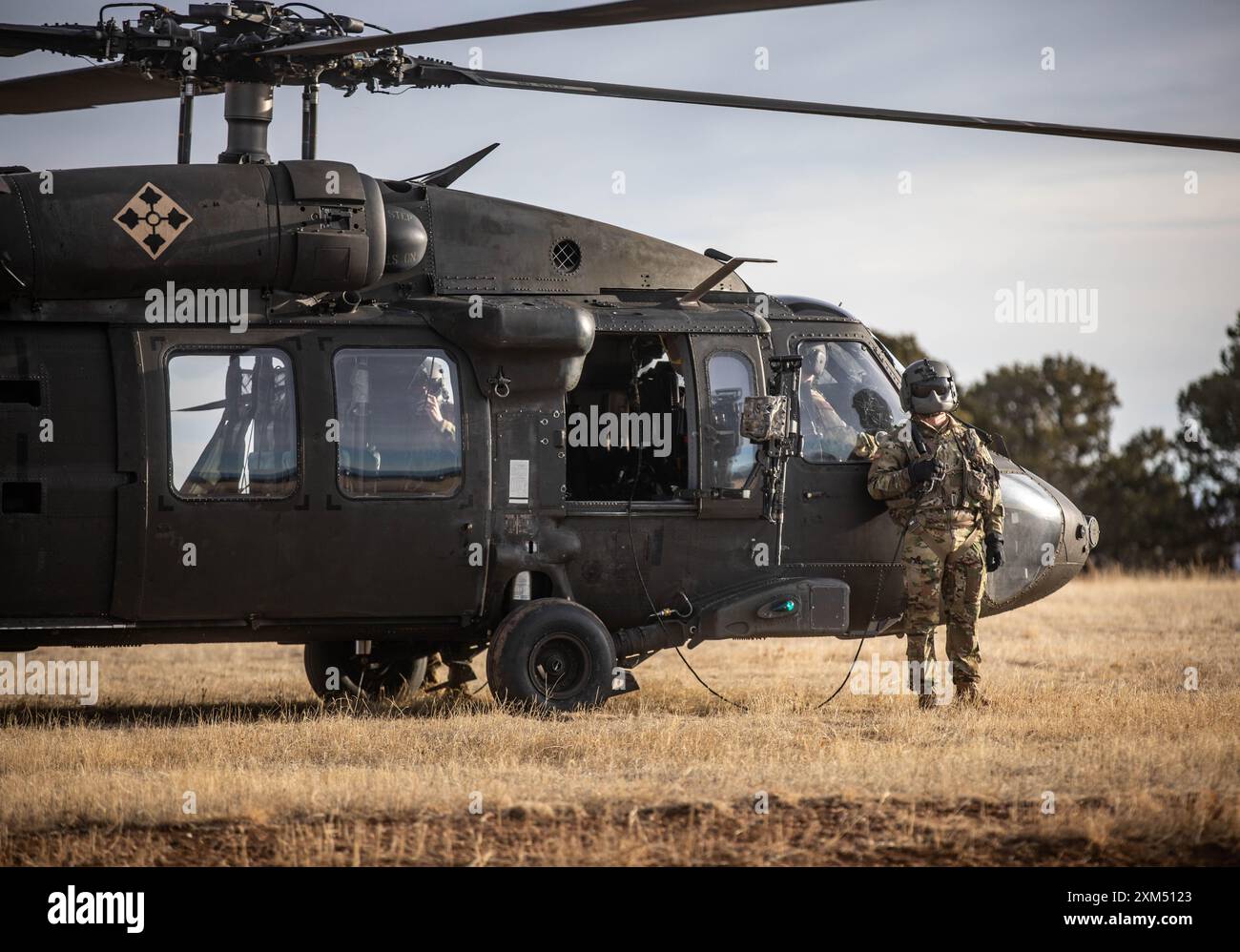 An Ivy Eagle stands next to a UH-60 Black Hawk waiting for Soldiers to ...