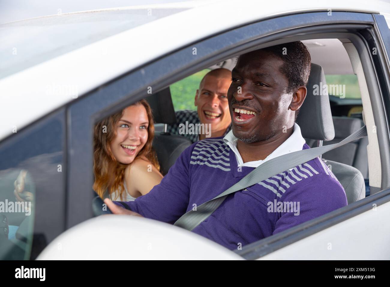 Happy friends driving in the car with open windows Stock Photo - Alamy