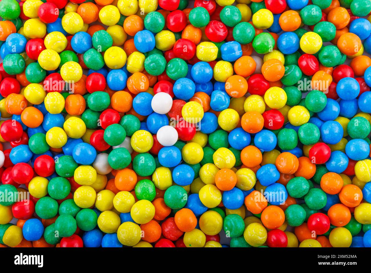 Colorful background of assorted shiny round gumballs. Background photo ...