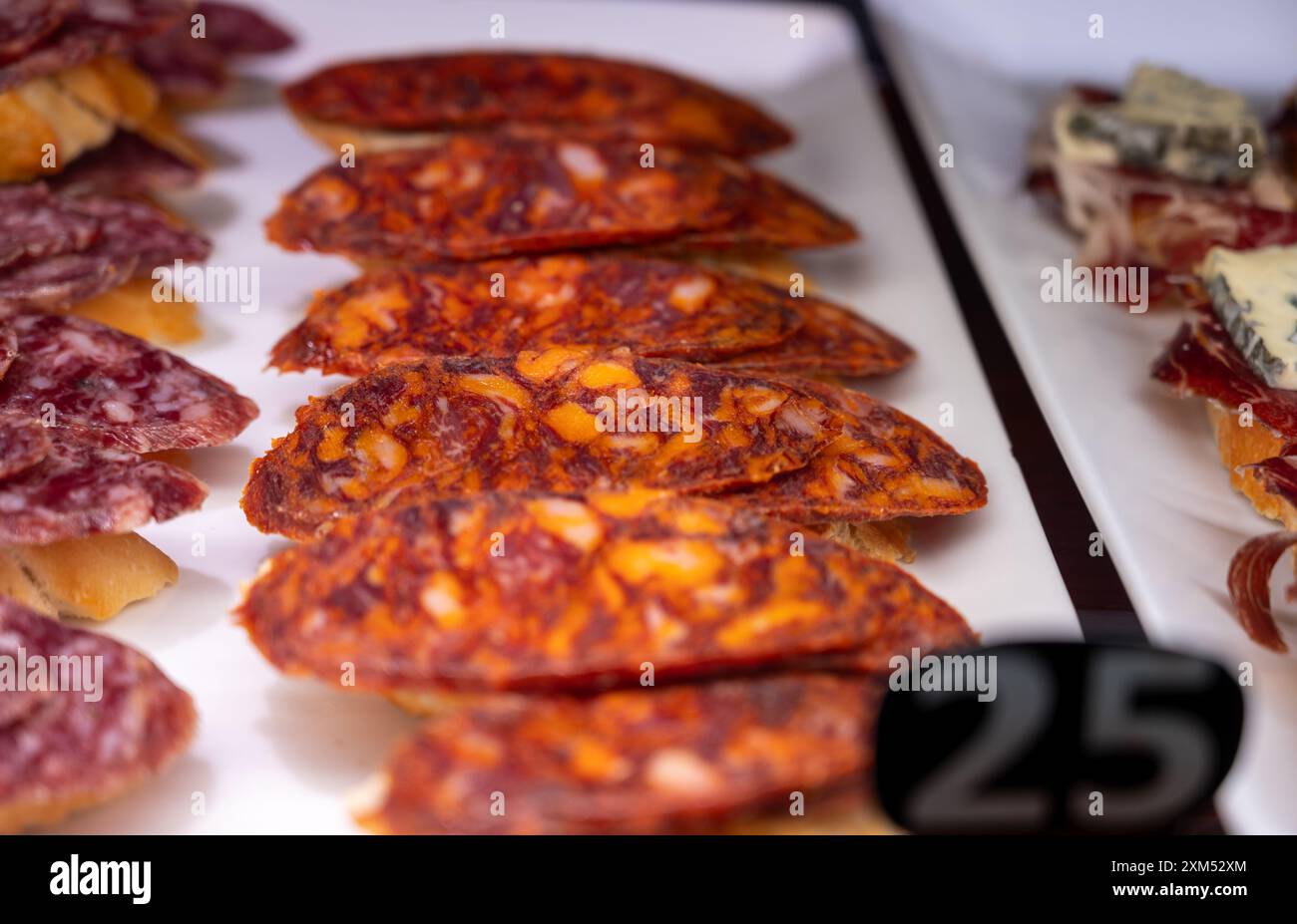 Typical snack of Basque Country, pinchos or pinxtos skewers with small ...