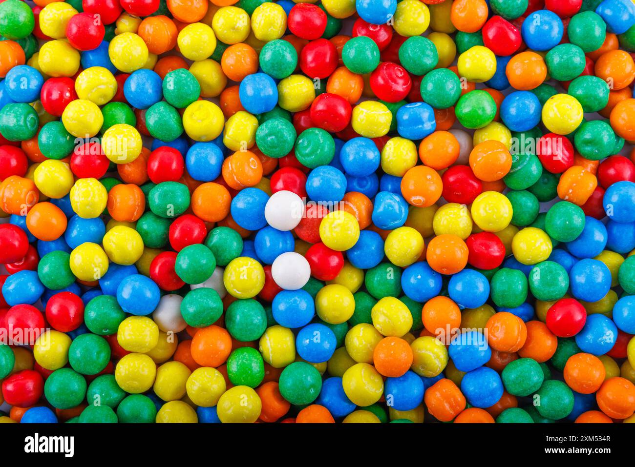 Colorful background of assorted shiny round gumballs. Background photo of multicolored gumballs ...