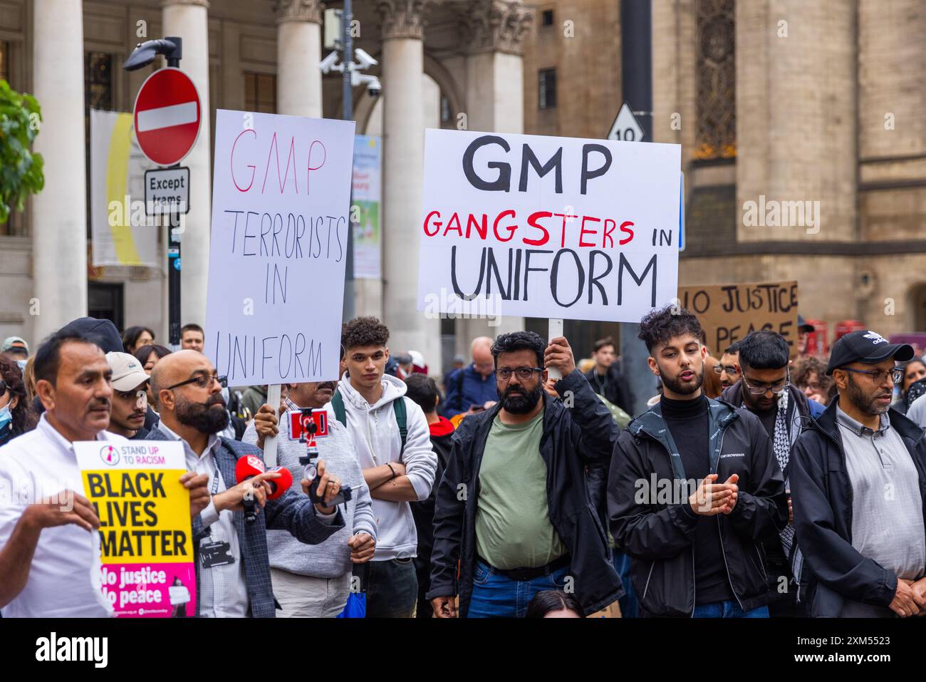 Manchester, UK. 25 JUL, 2024. Activists hold signs as protestors ...