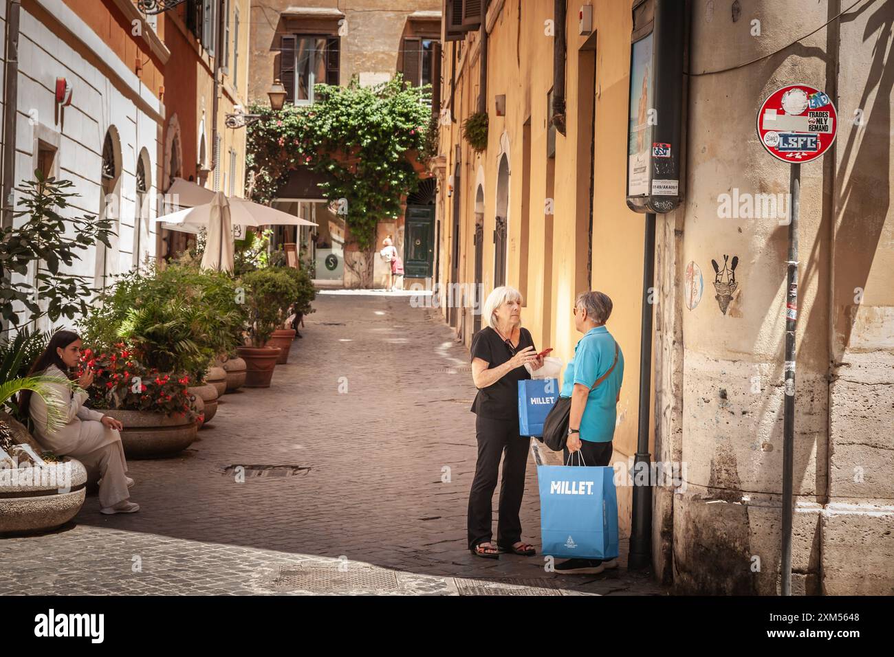 In this candid image, two elderly women are seen engaging in a lively ...