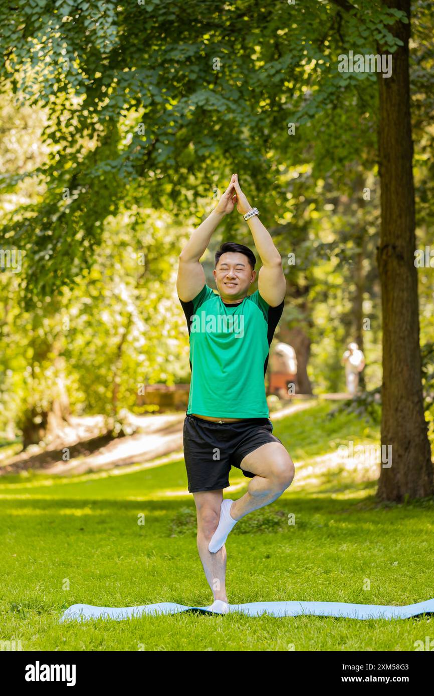 Calm muscular chinese sportsman balances hi-res stock photography and ...