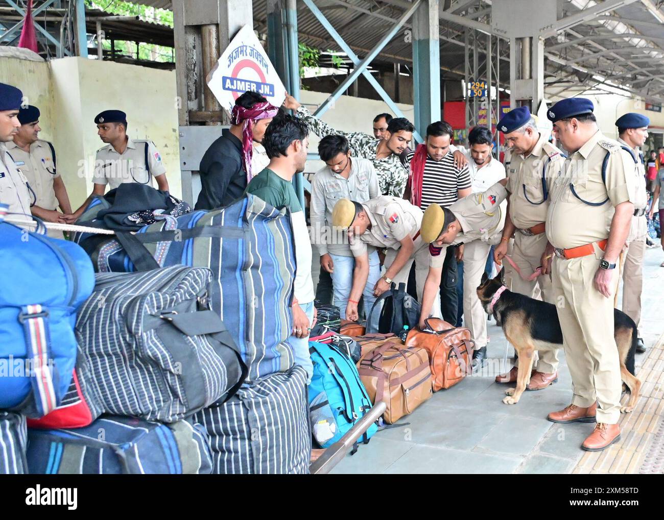Policemen check passengers' luggage at Ajmer railway station. Security ...