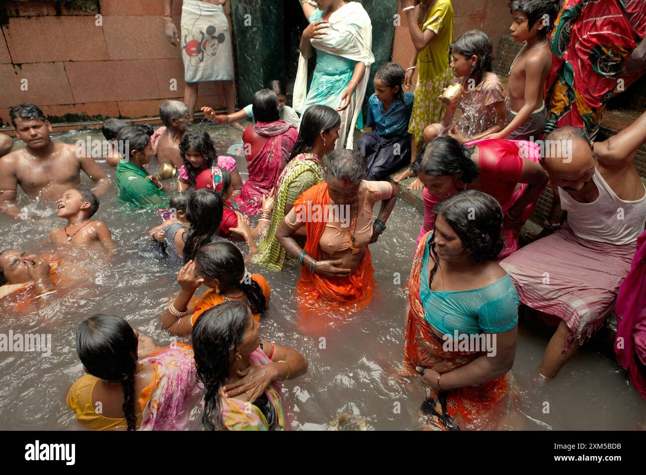People taking a bath at a hot spring, which is believed to have ...