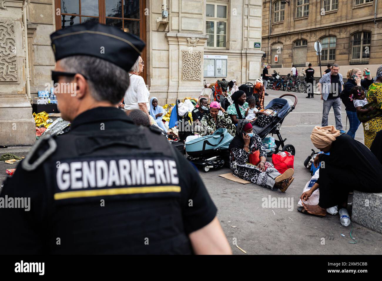 Homeless people await a housing solution in front of the 18th arrondissement Town Hall, under ...