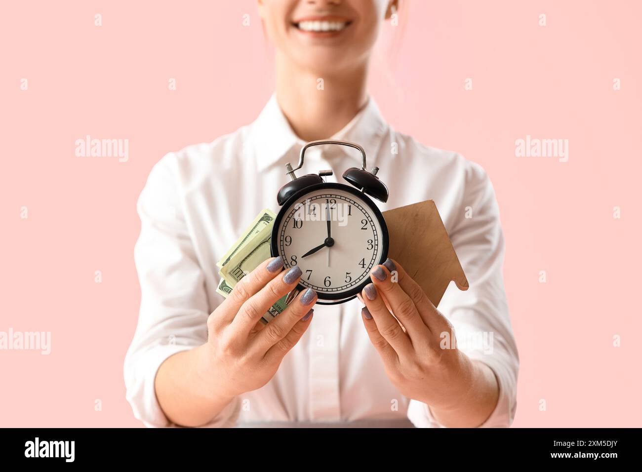 Female real estate agent with alarm clock, house model and money on ...