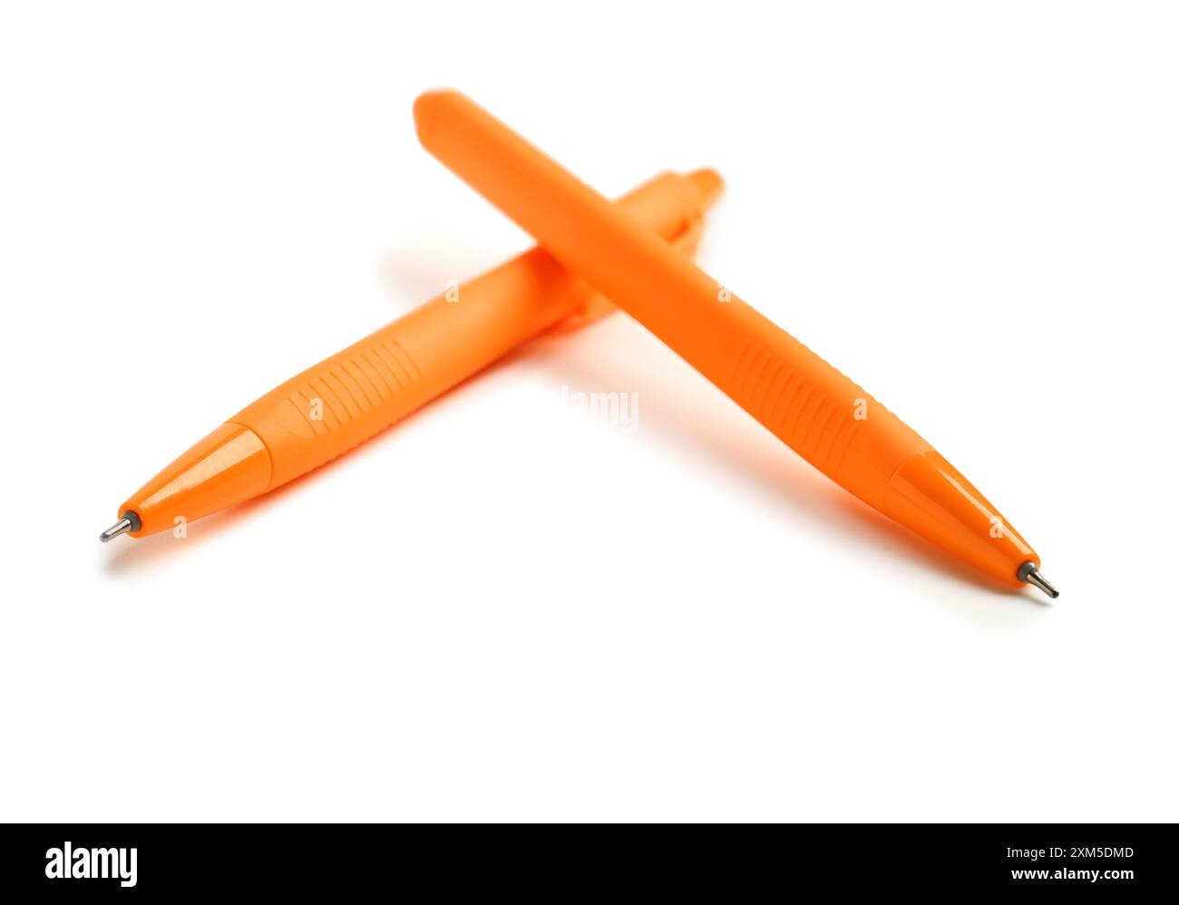 Orange ballpoint pens on white background Stock Photo - Alamy