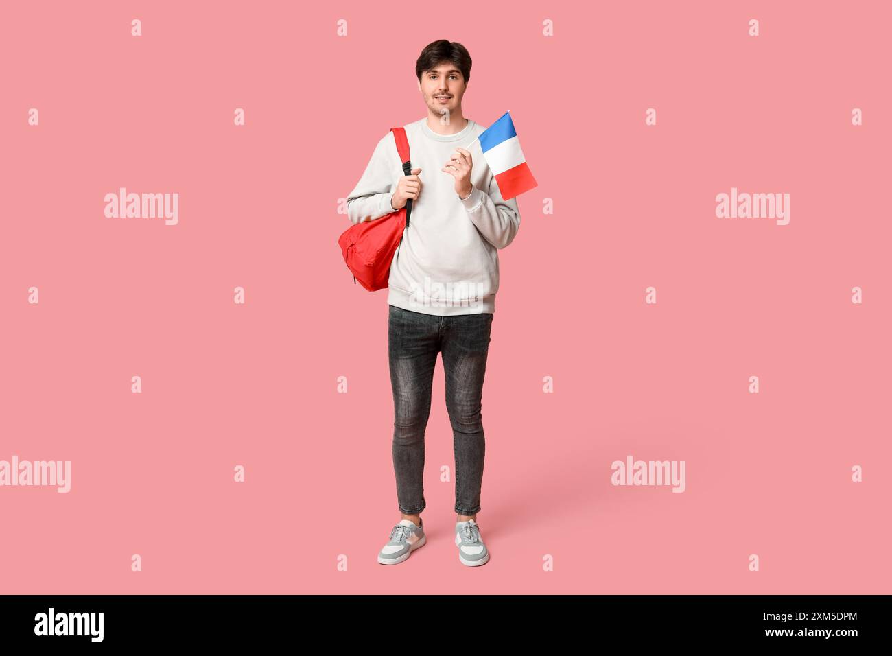 Male student with French flag on pink background Stock Photo - Alamy