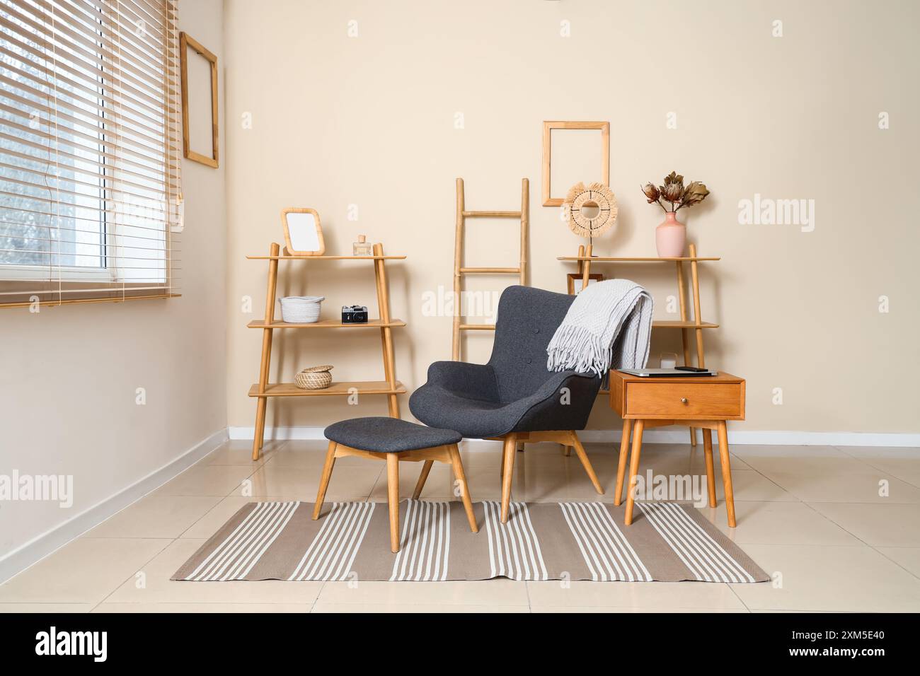 Stylish interior of living room with armchair Stock Photo - Alamy